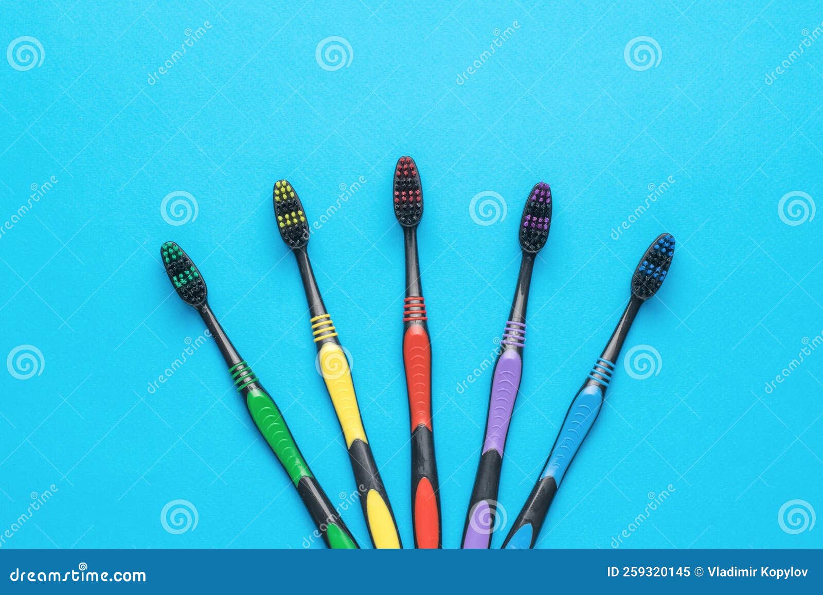 Five Multi-colored Toothbrushes on a Blue Background. Flat Lay Stock ...