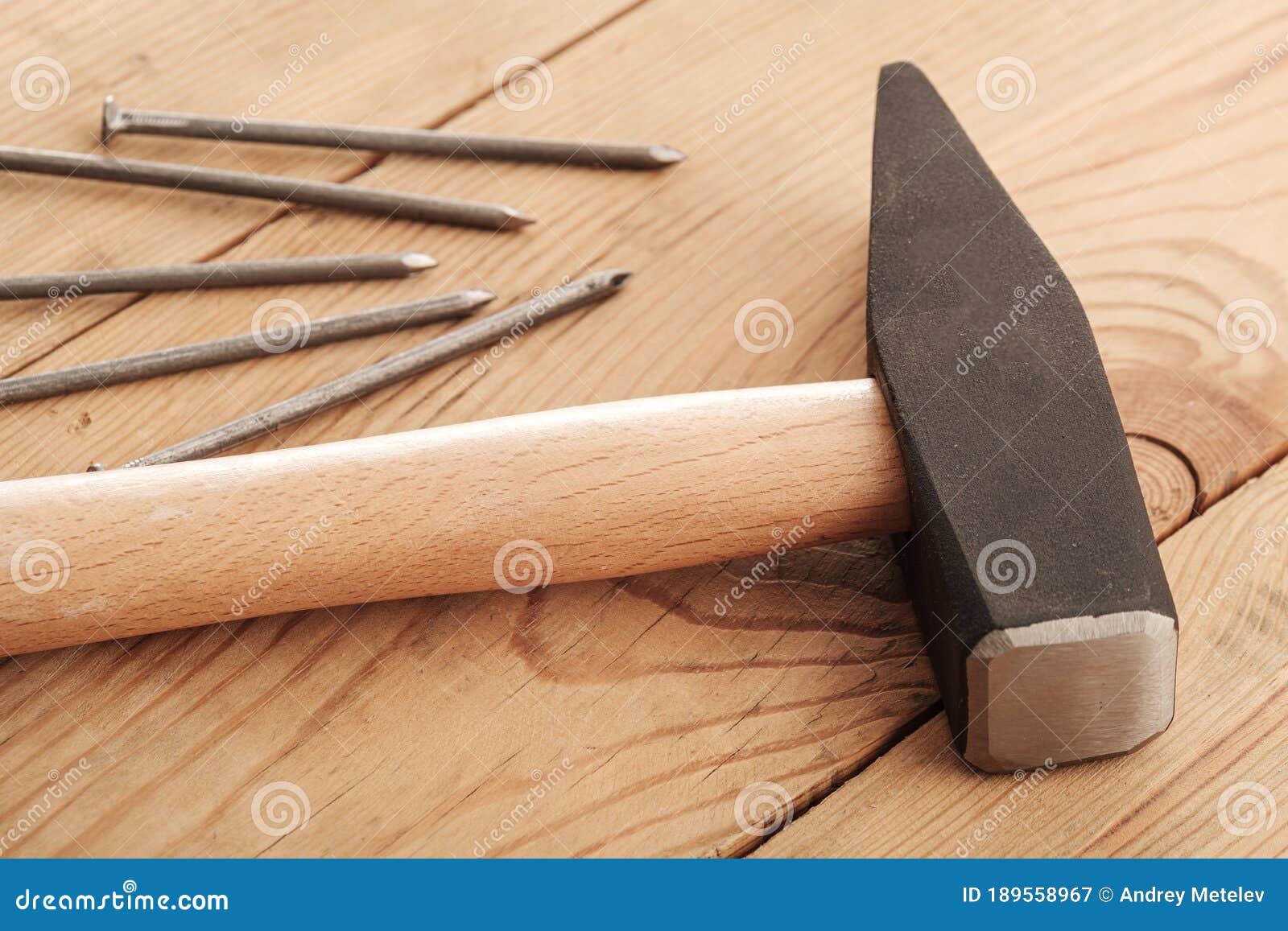 Five Nails and One Hammer on a Wooden Texture Stock Image - Image of ...