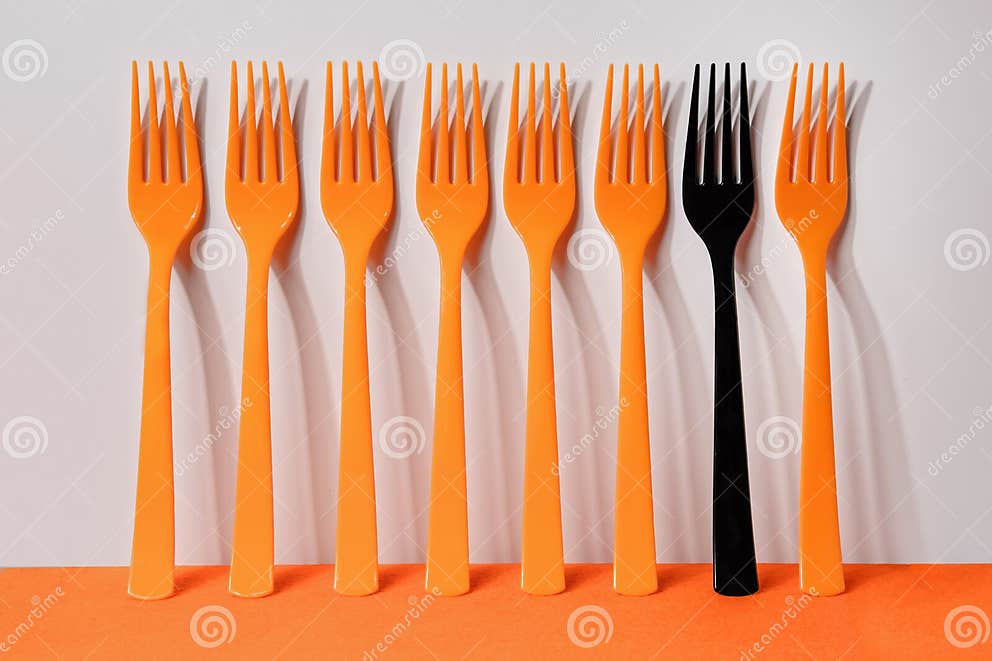 Five Orange Plastic Forks on Orange and White Background Stock Photo ...