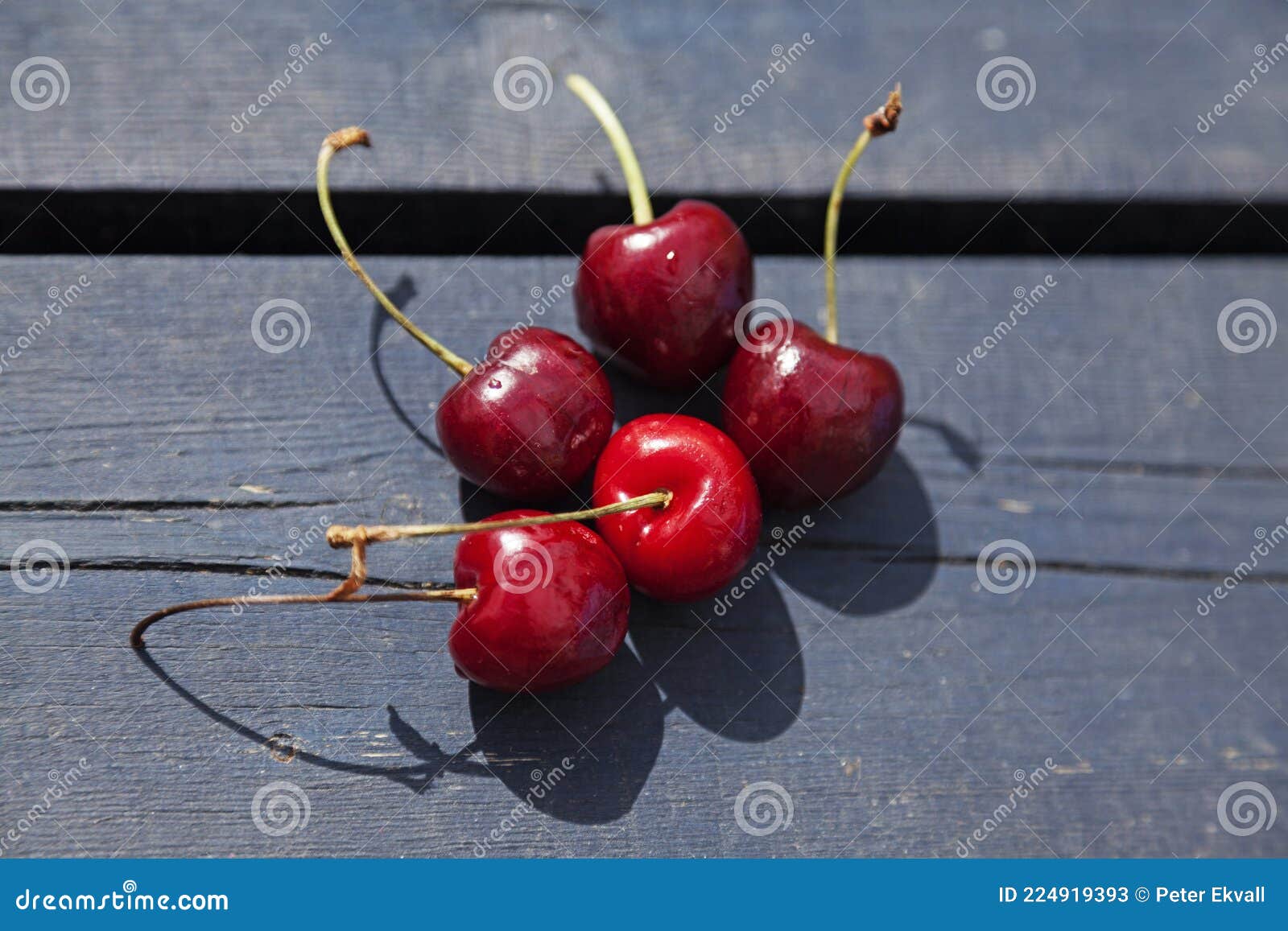 Five Red Cherries on a Wooden Table Stock Image - Image of norrland ...