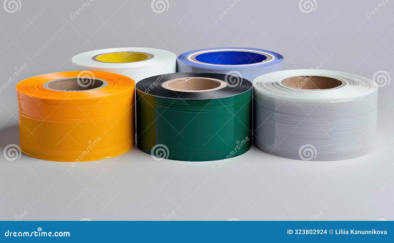 Five Rolls of Adhesive Tape in Various Colors on a Gray Surface Stock ...