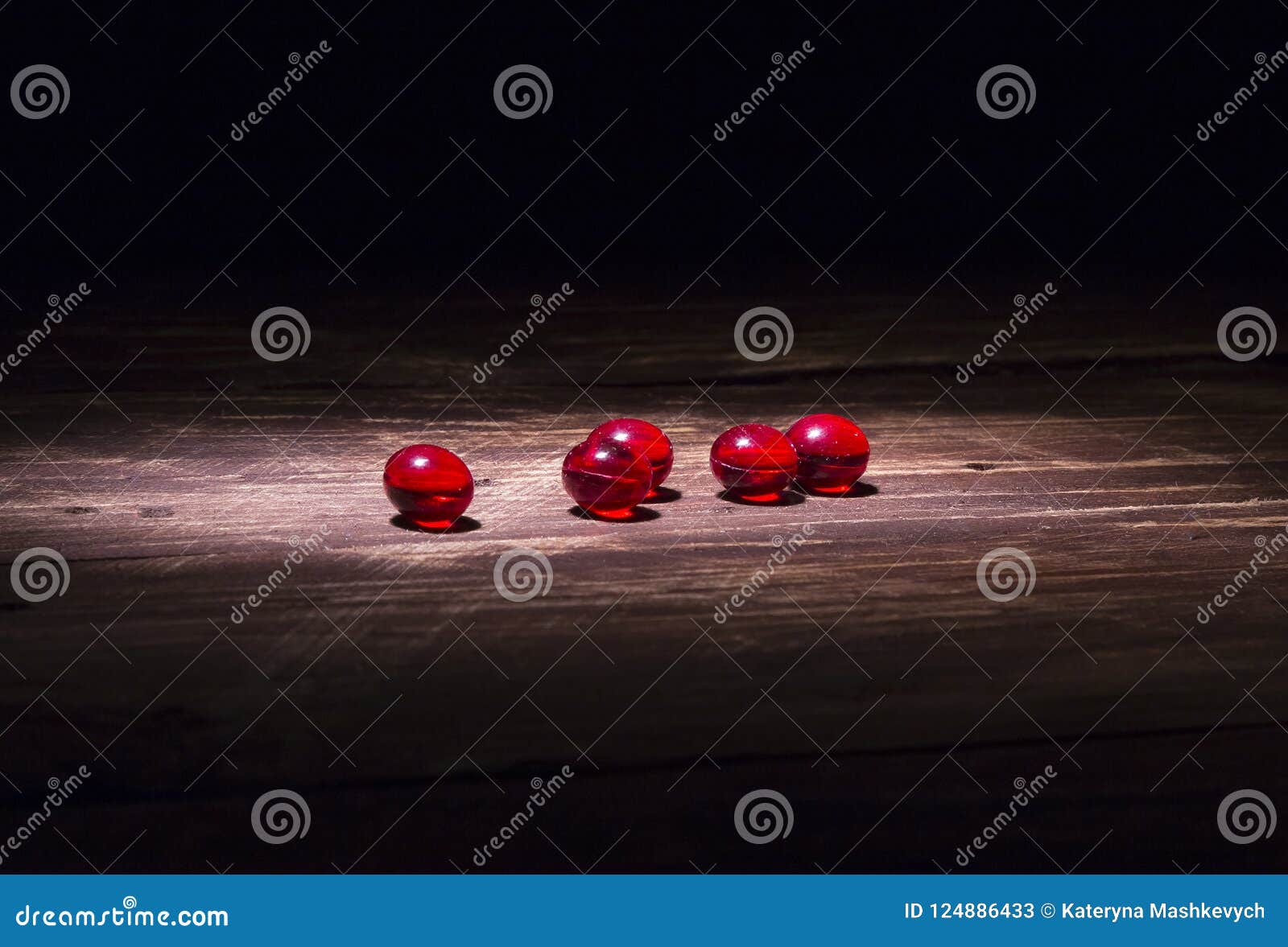 Five Translucent Tablets in a Gelatin Capsule Vitamin a on a Wooden ...