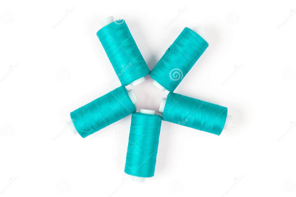 Five Turquoise Sewing Threads Laying in a Circle on a White Background ...