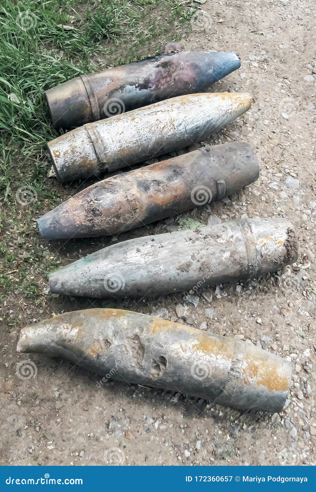 Five Unexploded Artillery Shells Lie on the Side of the Asphalt Road ...