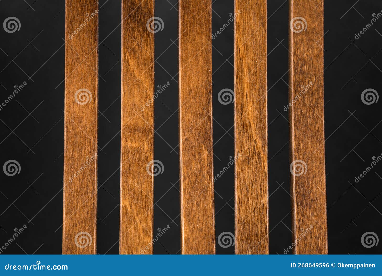 Five Vertical Wooden Bars Against the Black Fabric Background Stock ...