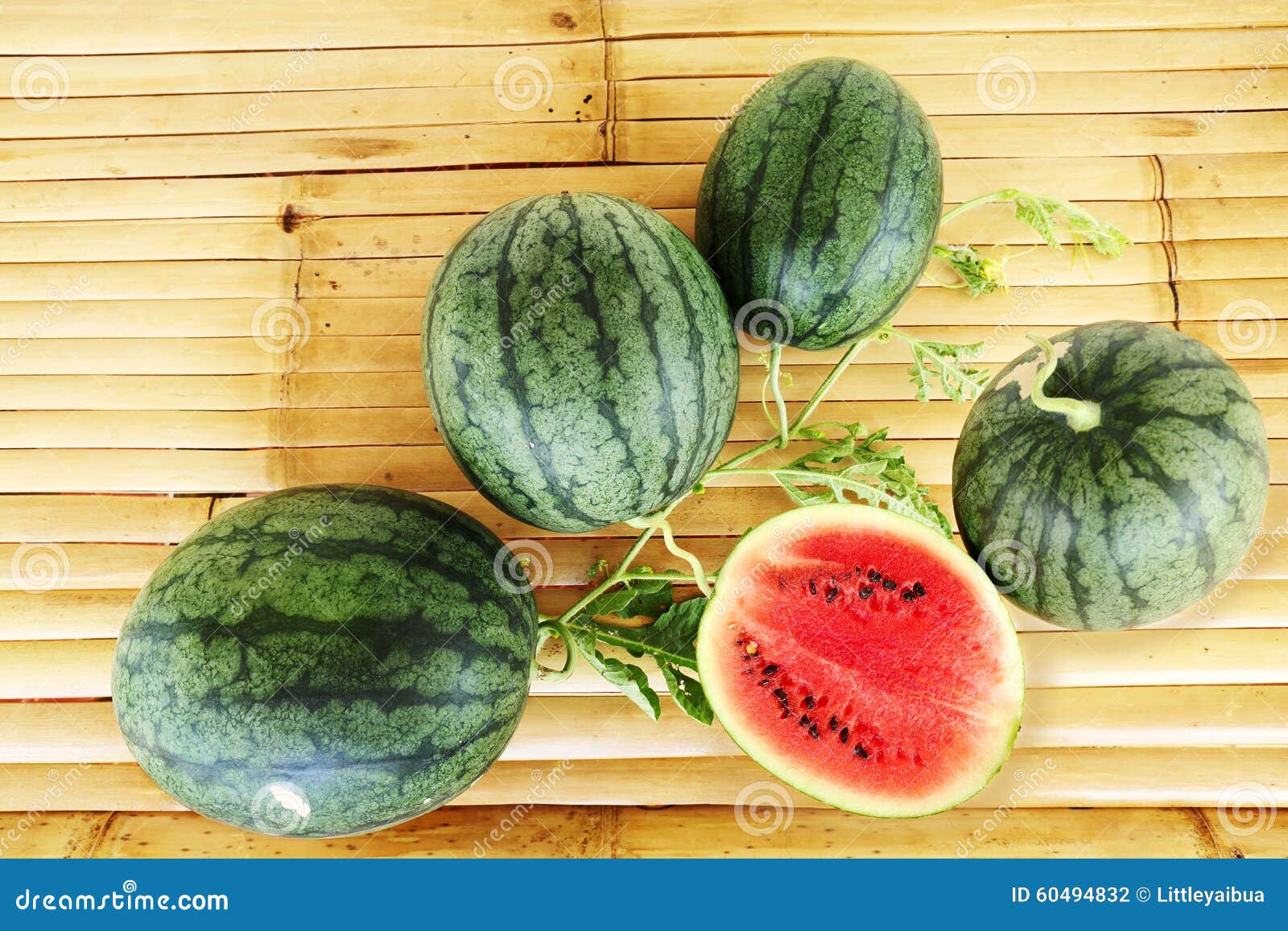 Five Watermelon with a Slice and Leaves on a Bamboo Table. Stock Photo ...
