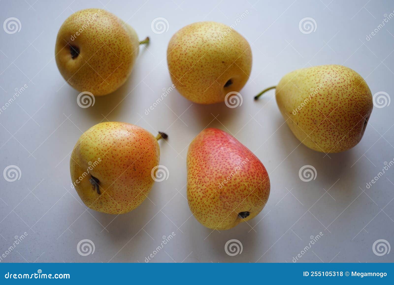 Five Yellow Orange Pears on a White Sunny Table Stock Photo - Image of ...