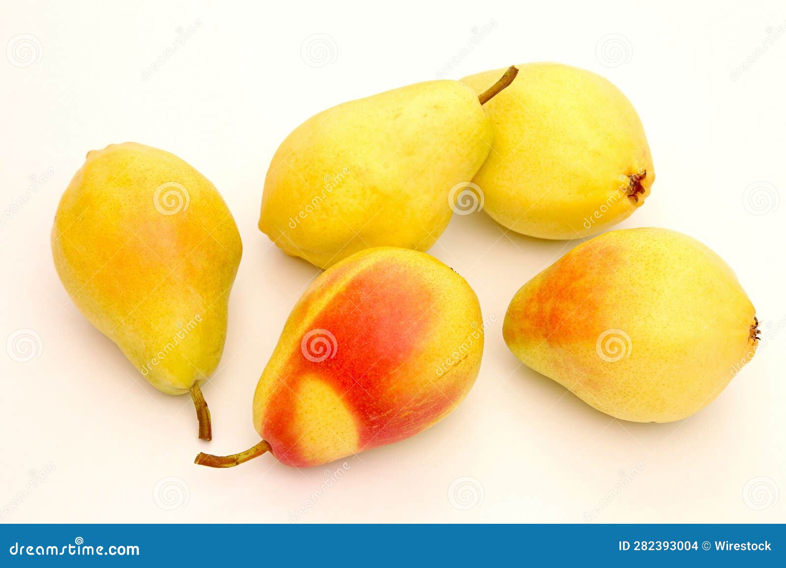 Five Yellow Pears and One Orange Pear Sit on the White Surface Stock ...
