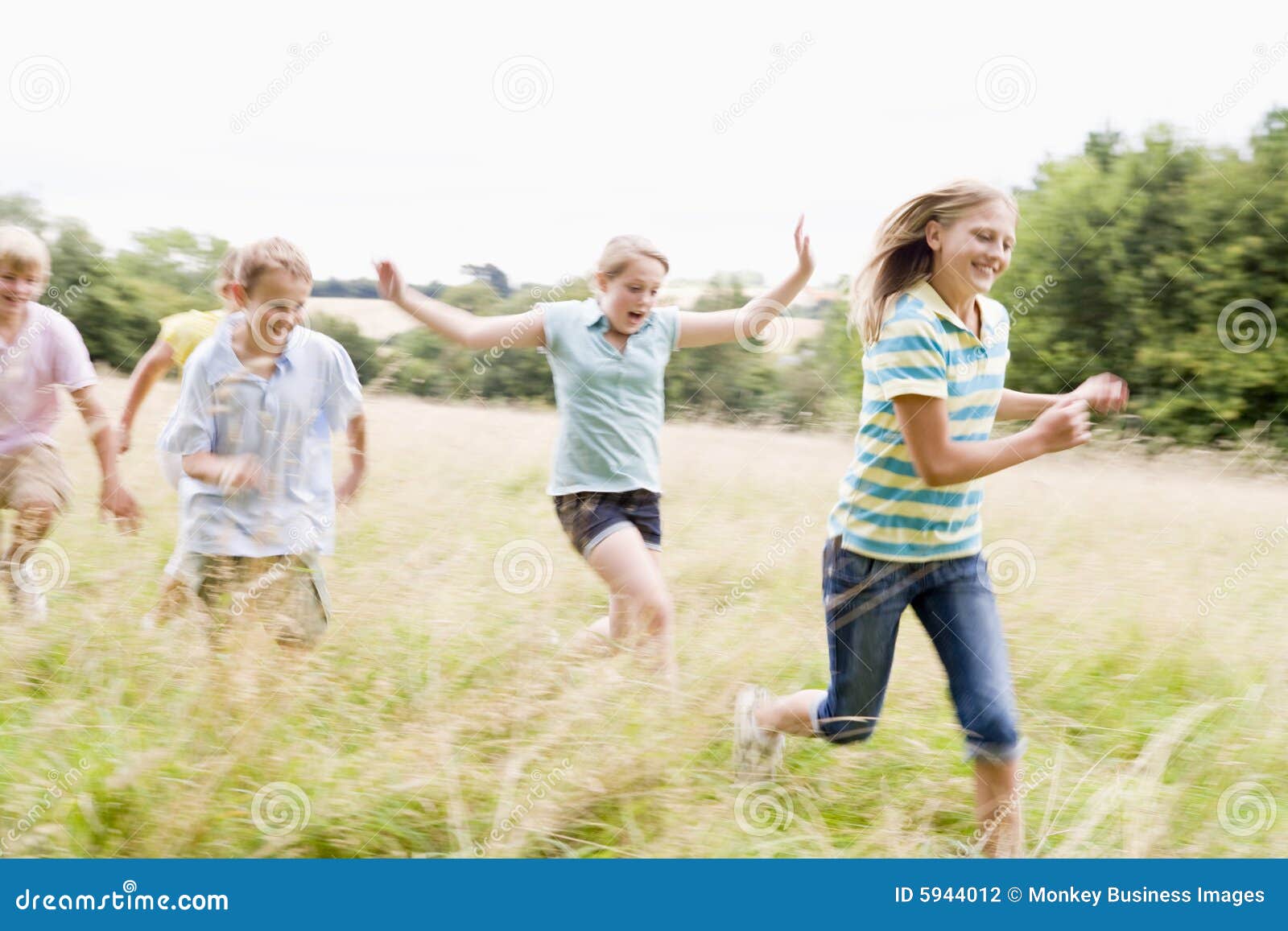 Five Young Friends Running in a Field Smiling Stock Photo - Image of ...