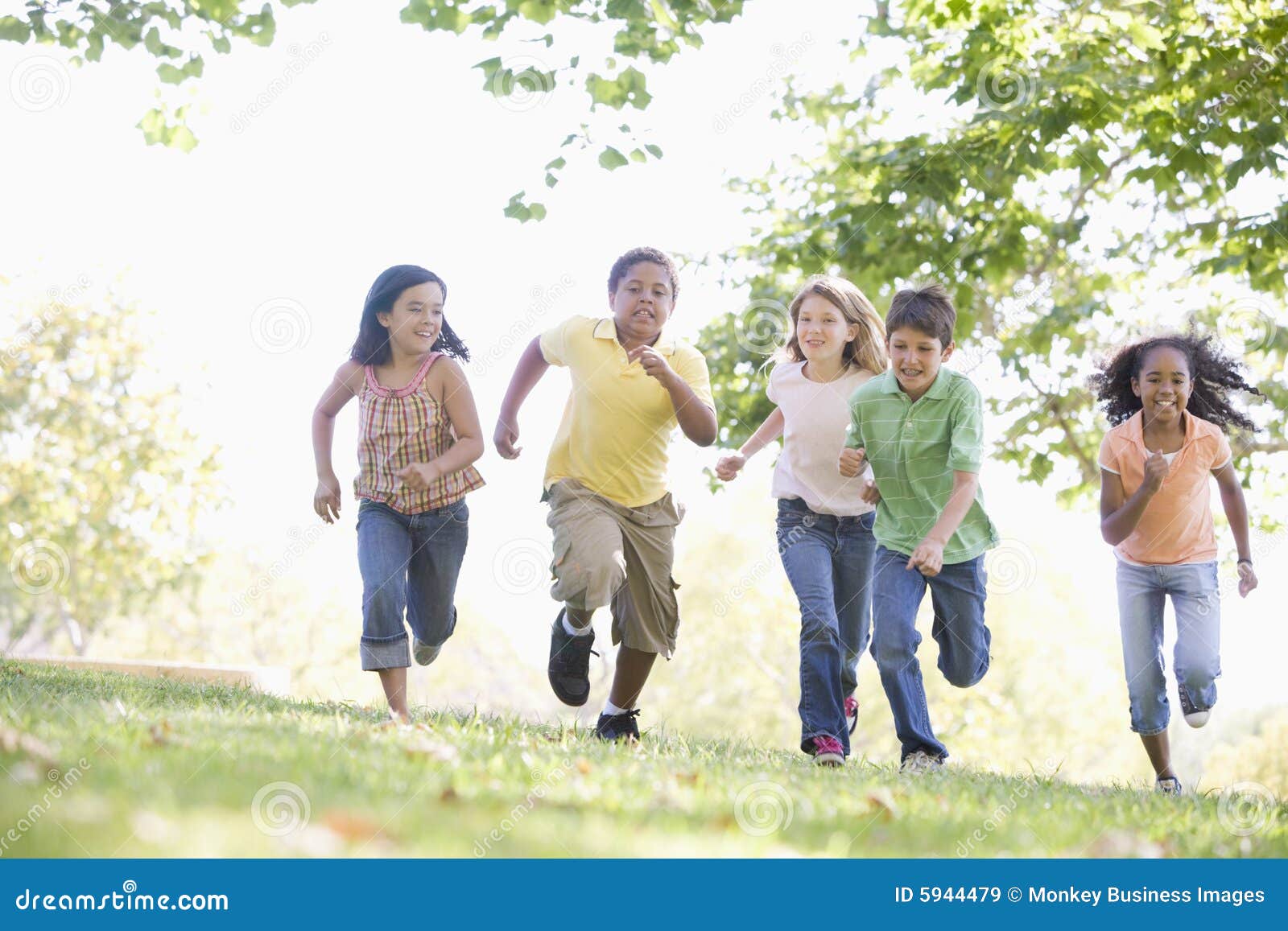 Five Young Friends Running Outdoors Smiling Stock Image - Image of girl ...