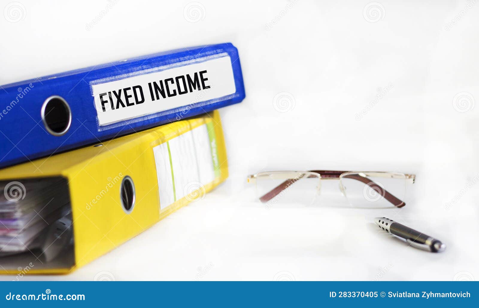 FIXED INCOME Text on Blue Folder with Pen, Glasses on White Background ...