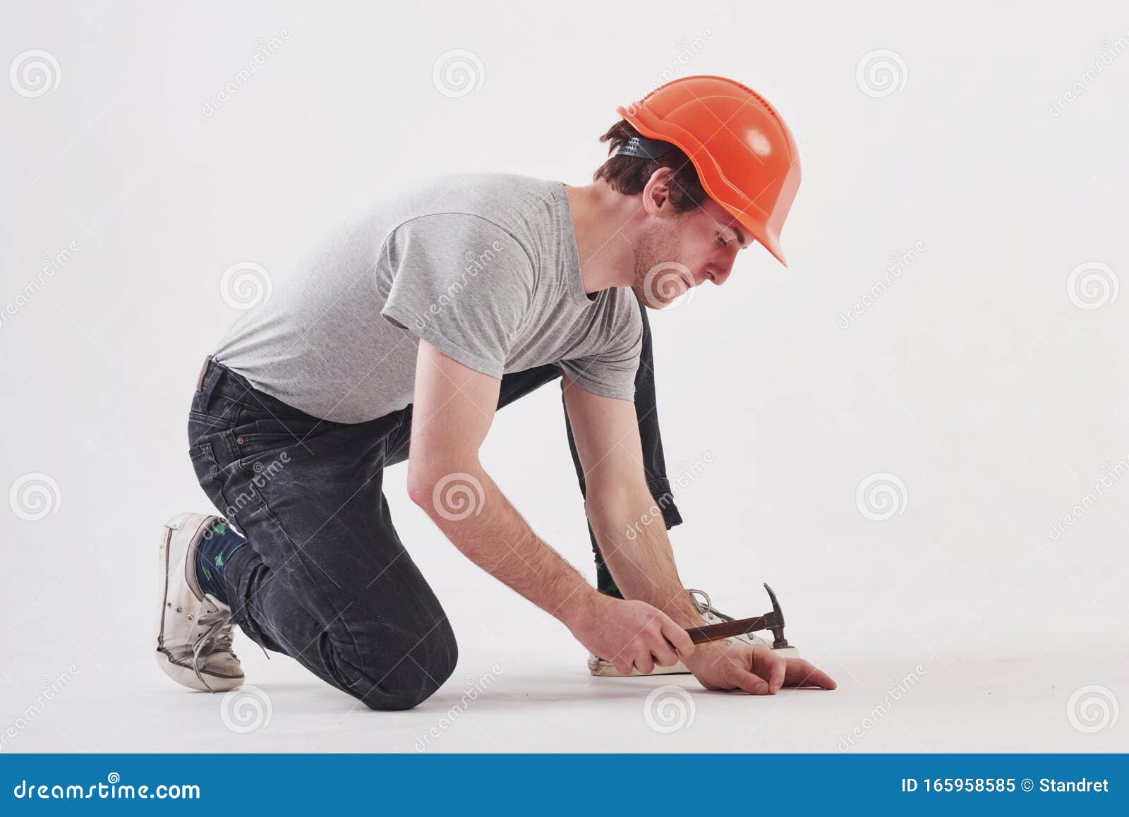 Fixing the Floor. Man in Casual Clothes and Orange Colored Hard Hat ...