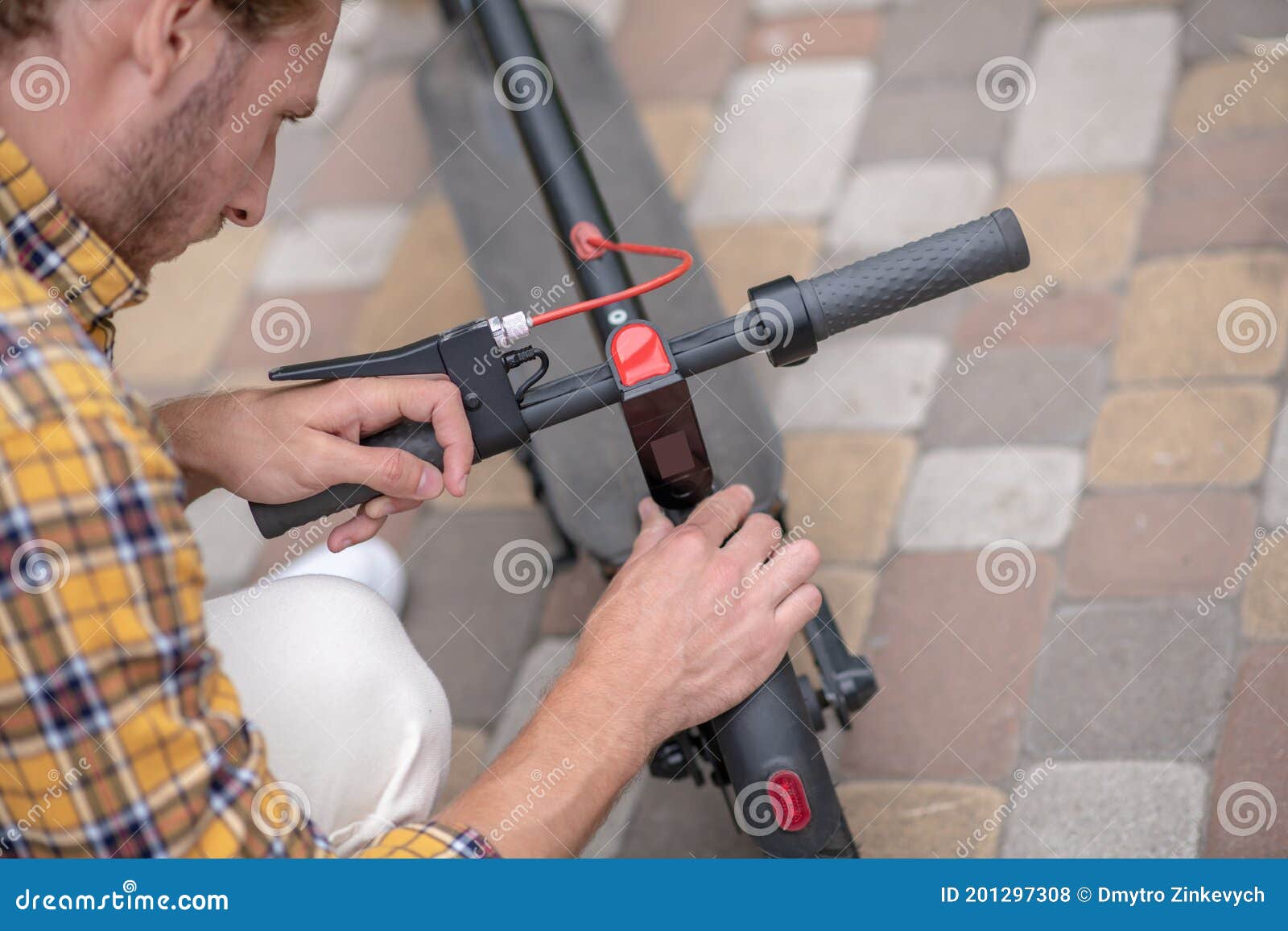 Young Man Fixing His Scooter and Looking Involved Stock Photo - Image ...