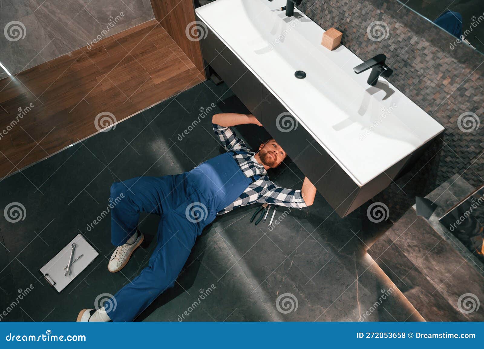 Fixing the Siphone. Lying Down on the Floor Stock Photo - Image of ...