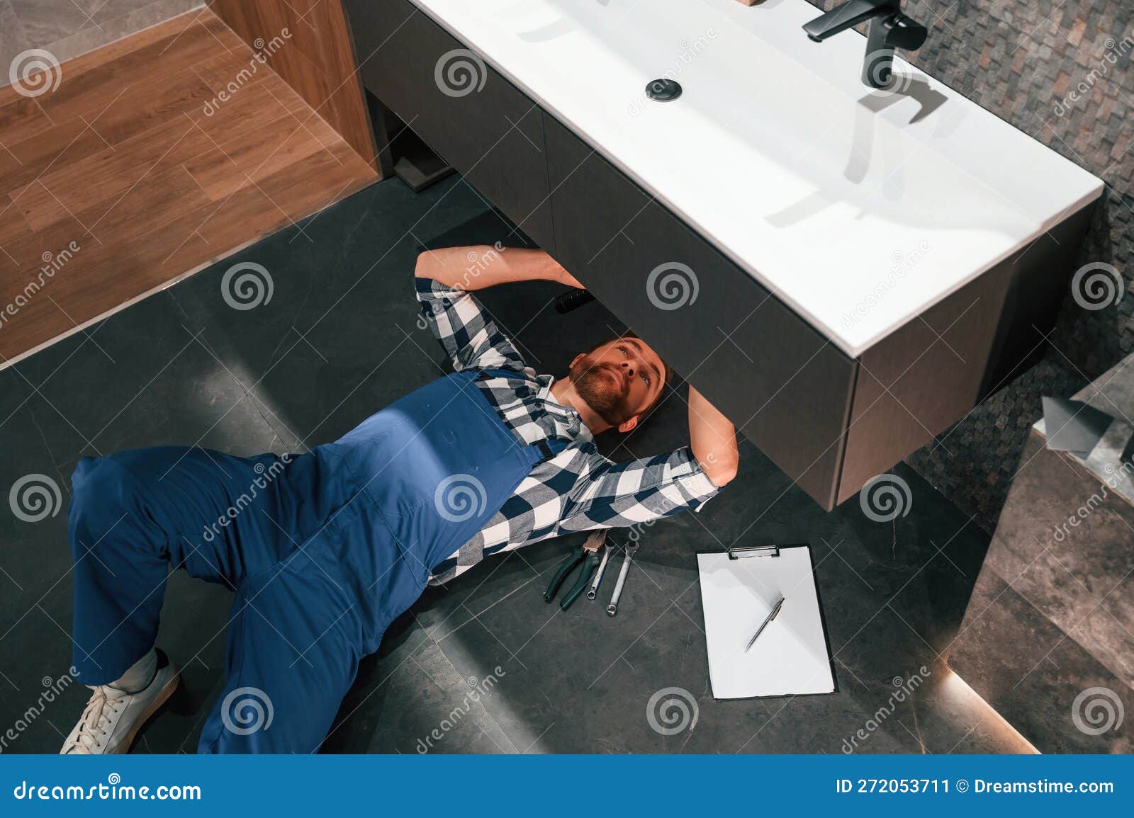 Fixing the Siphone. Lying Down on the Floor Stock Image - Image of ...