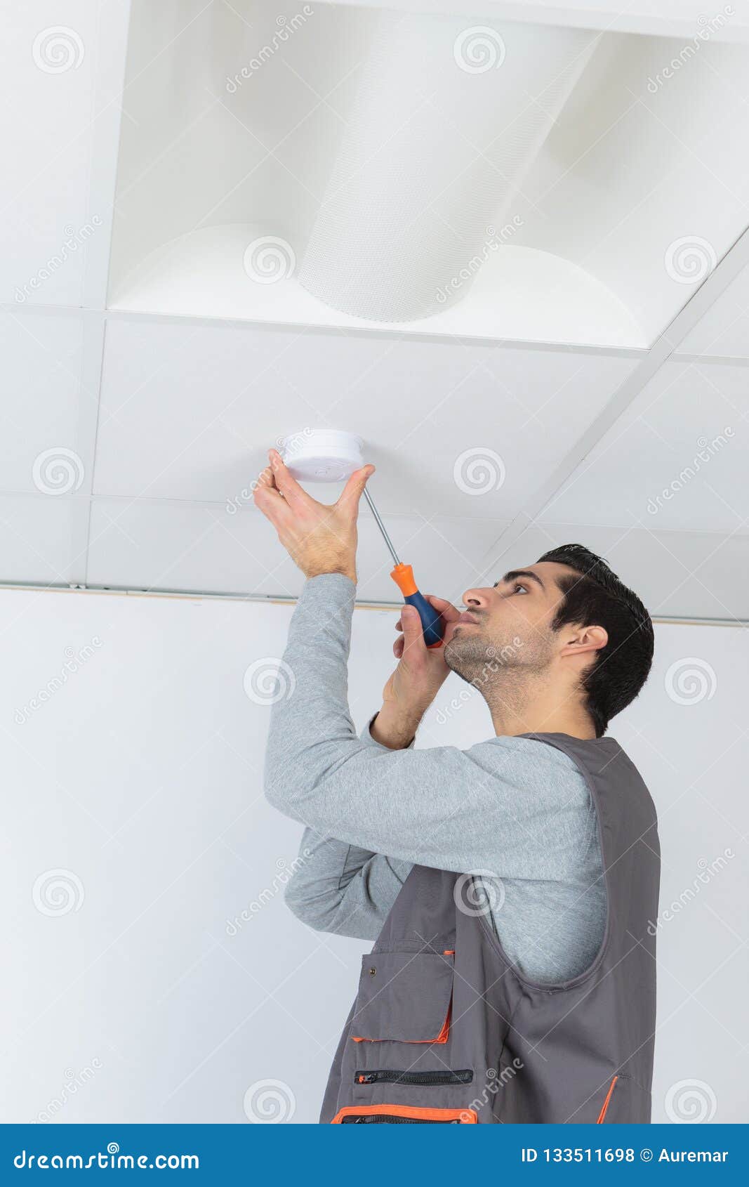 Fixing the smoke detector stock photo. Image of working - 133511698