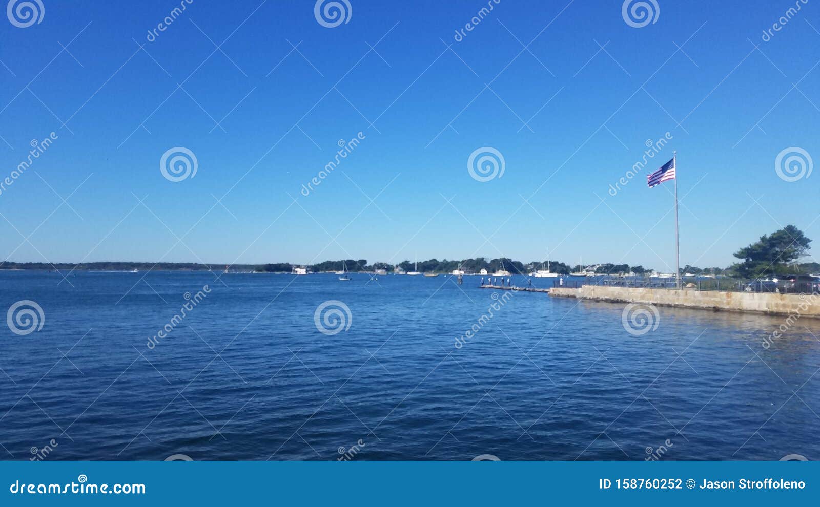 Flag in the Bay with Jetty stock photo. Image of capecod - 158760252