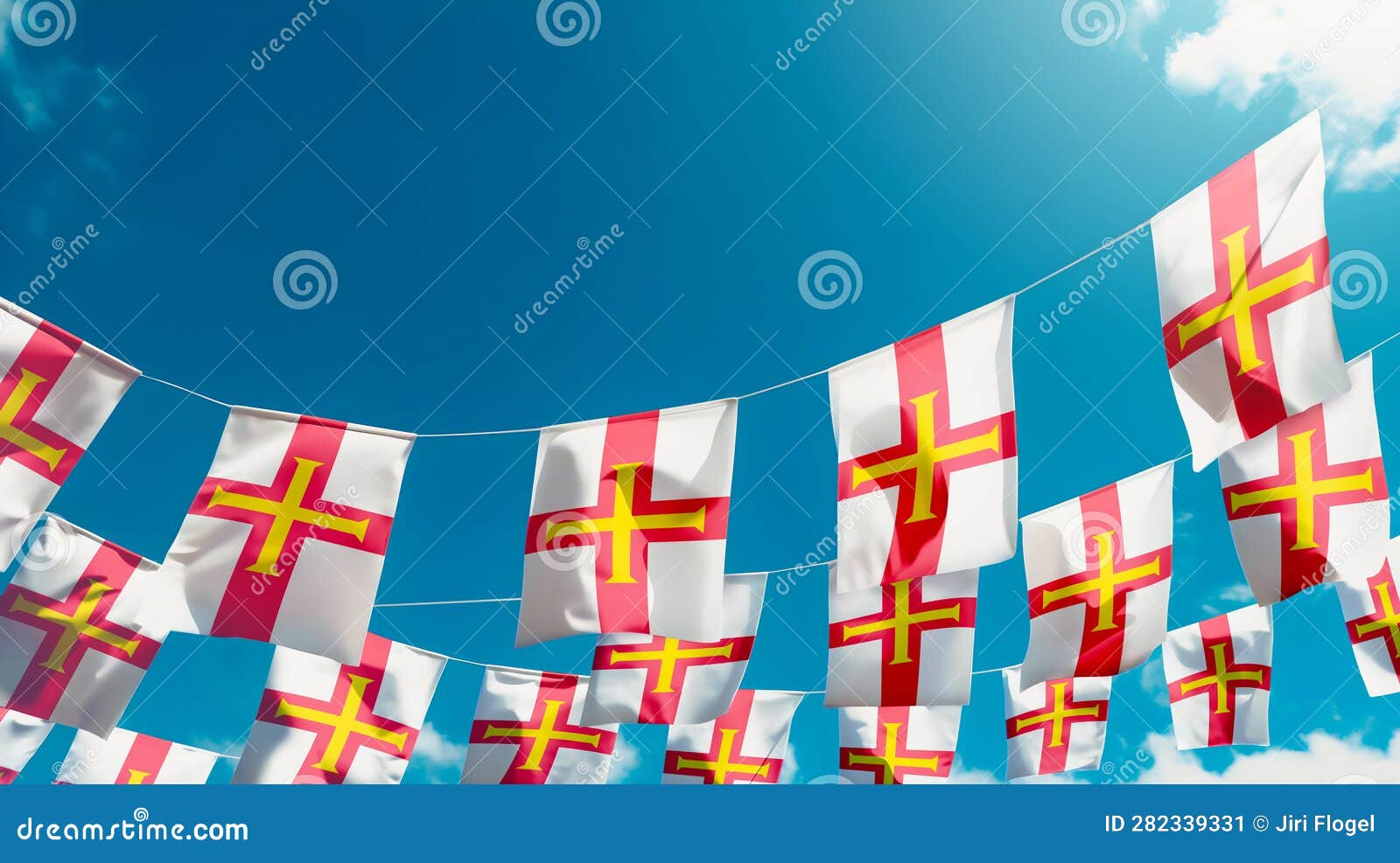 Flag of Guernsey Against the Sky, Flags Hanging Vertically Stock ...
