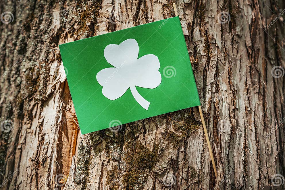 Flag with the Image of Clover on a Tree Trunk Stock Image - Image of ...