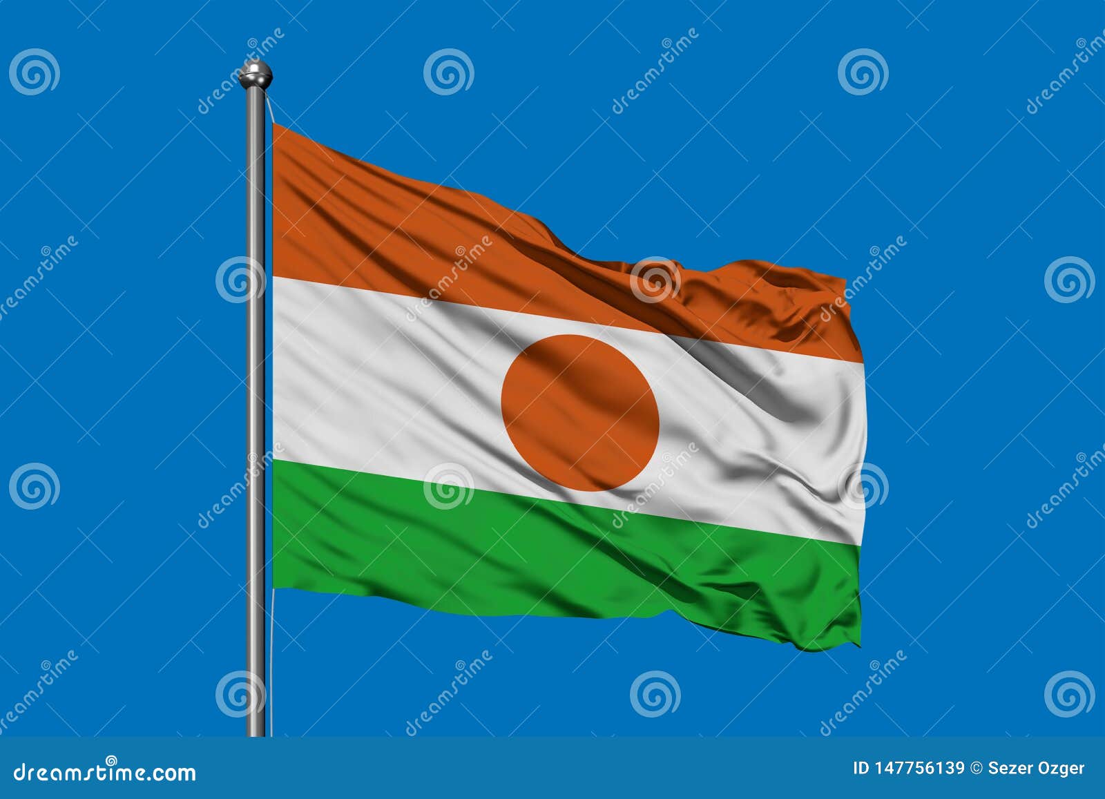 Flag of Niger Waving in the Wind Against Deep Blue Sky. Nigerien Flag ...