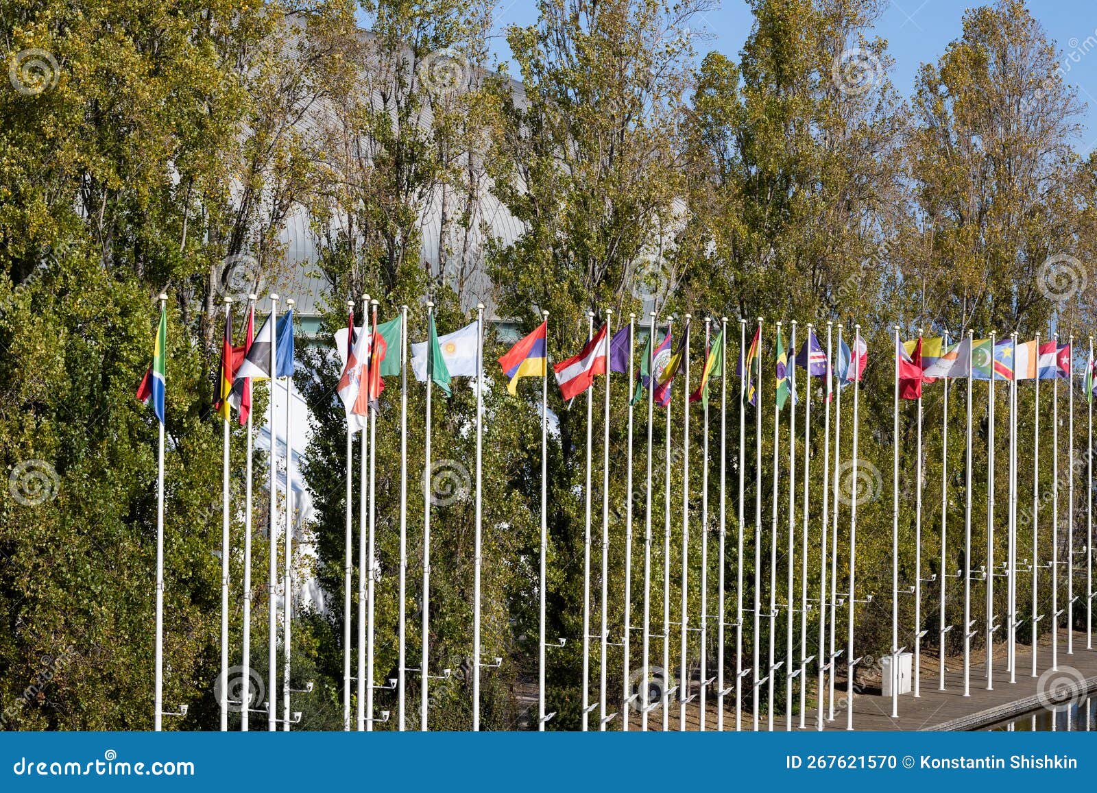 Flags of Different Countries on the Background of Trees Stock Photo ...