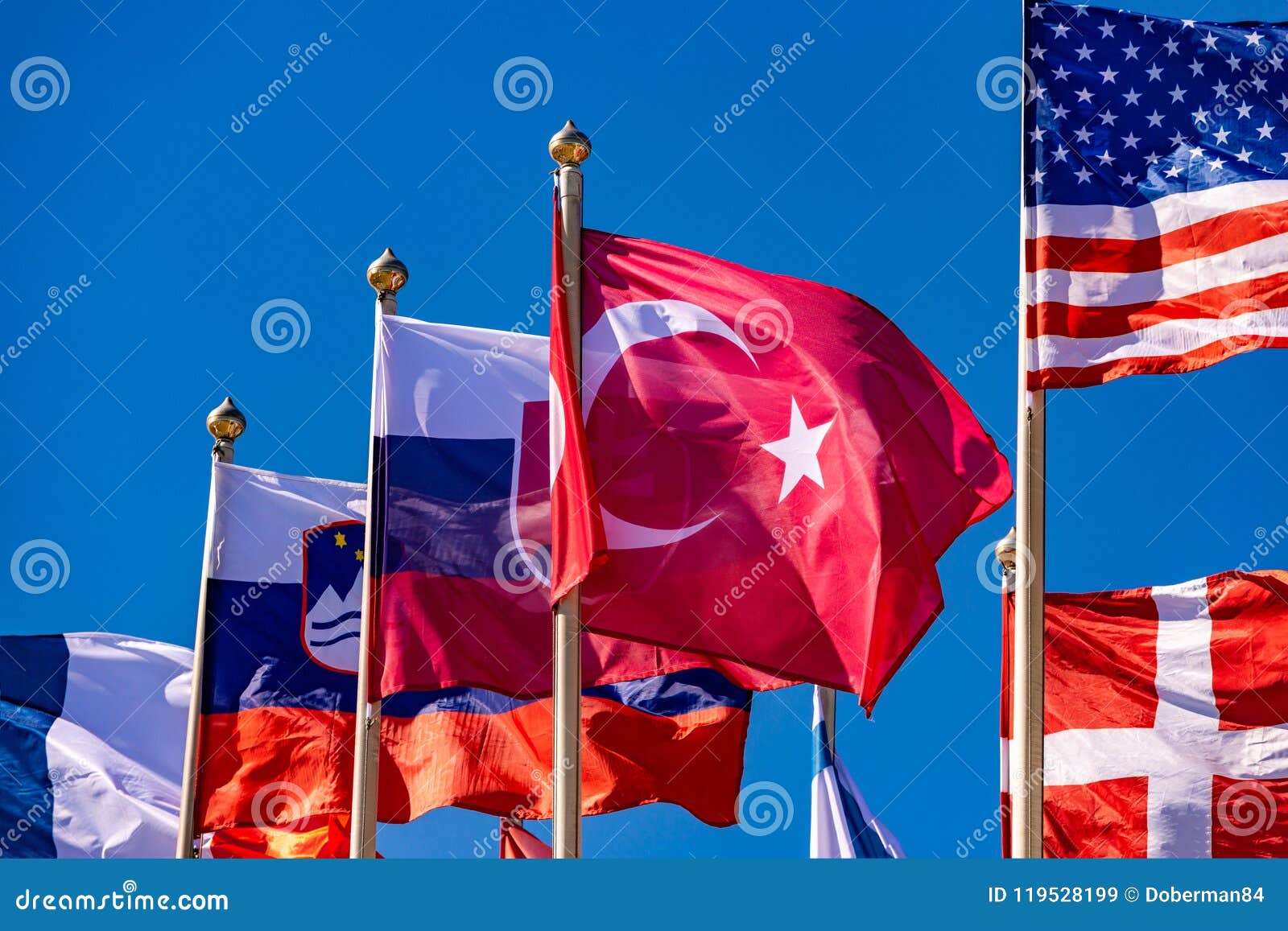 Flags of Different Countries Flutters in the Wind Against Stock Image ...