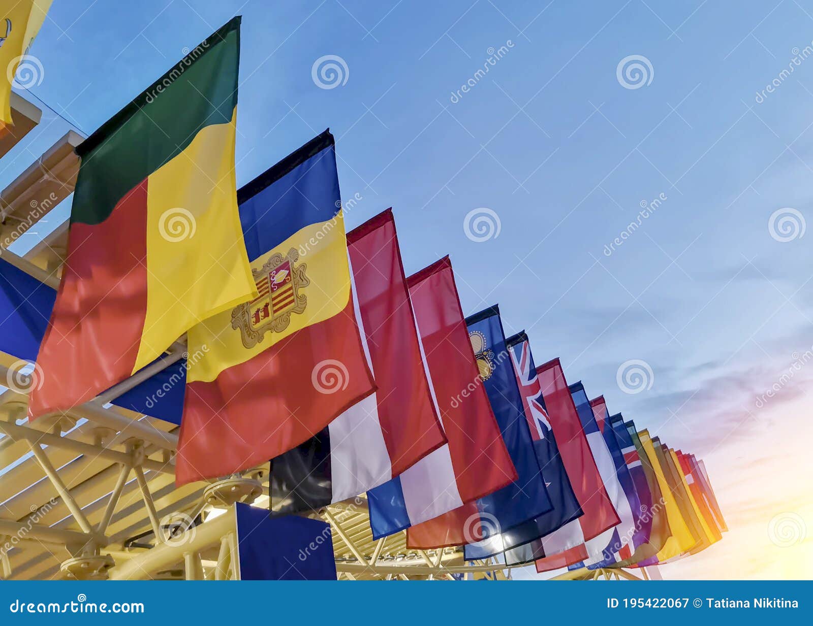 Flags of Different Countries Against the Backdrop of the Sunset Sky ...