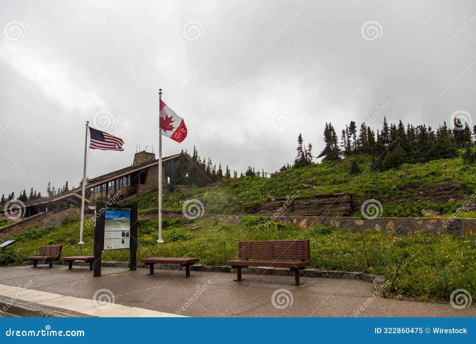 Flags Stand in the Background As Two Benches Sit Next To Each Other ...