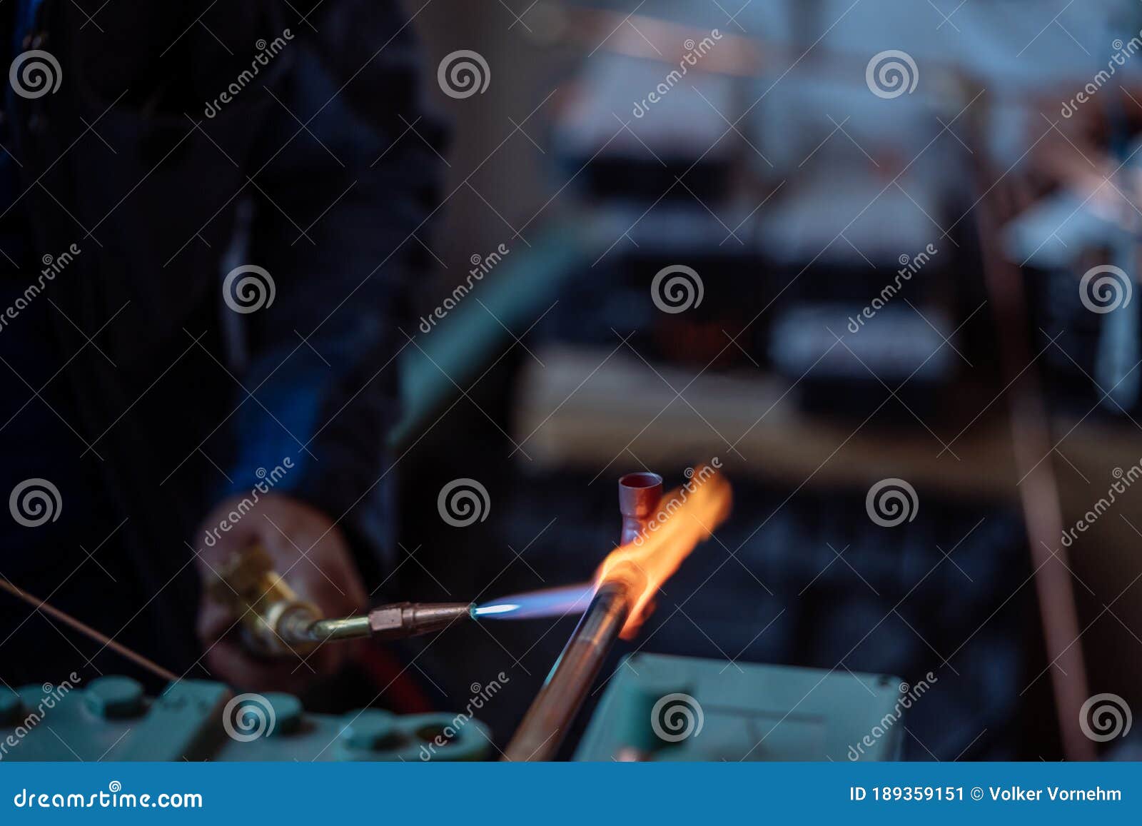 Flame of a Copper Welding Machine Heats a Copper Pipe in a Workshop ...
