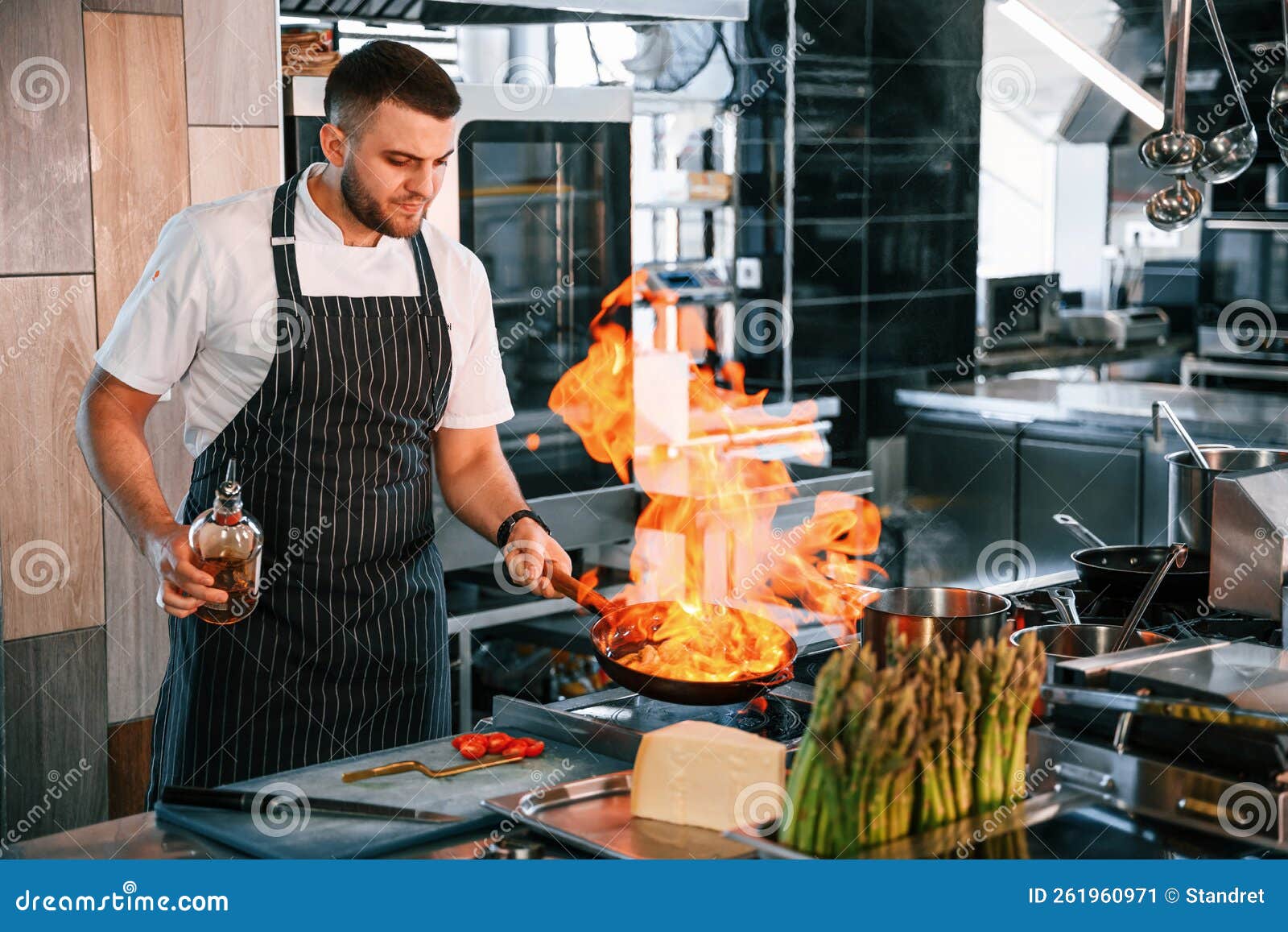 Flames on the Frying Pan. Chef is on the Kitchen Preparing Food Stock ...