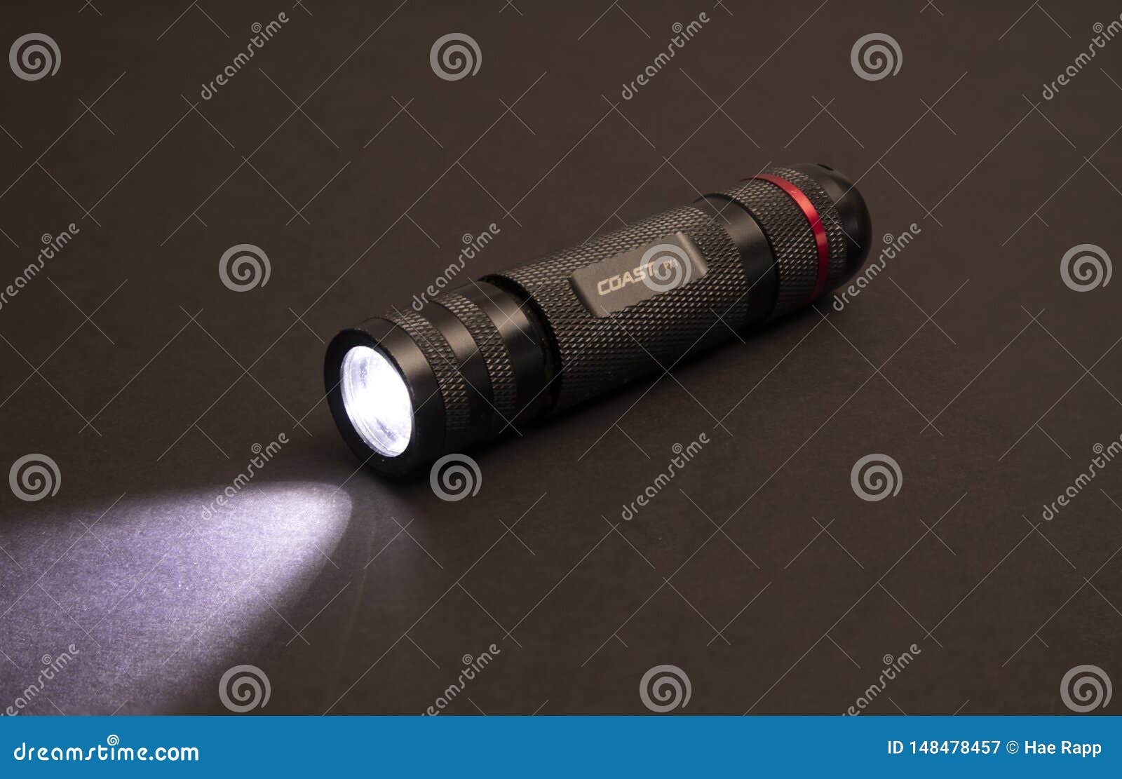 Flashlight with a Beam of Light Agaist a Black Background Editorial ...