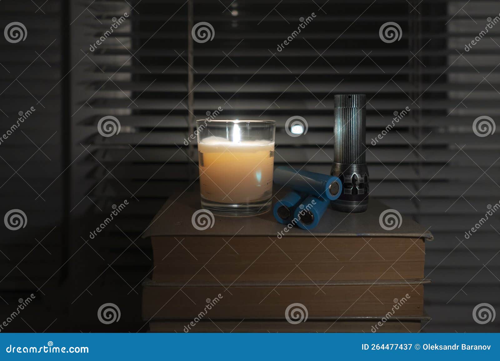 A Flashlight and Rechargeable Batteries Lie in a Dark Empty Room by the ...