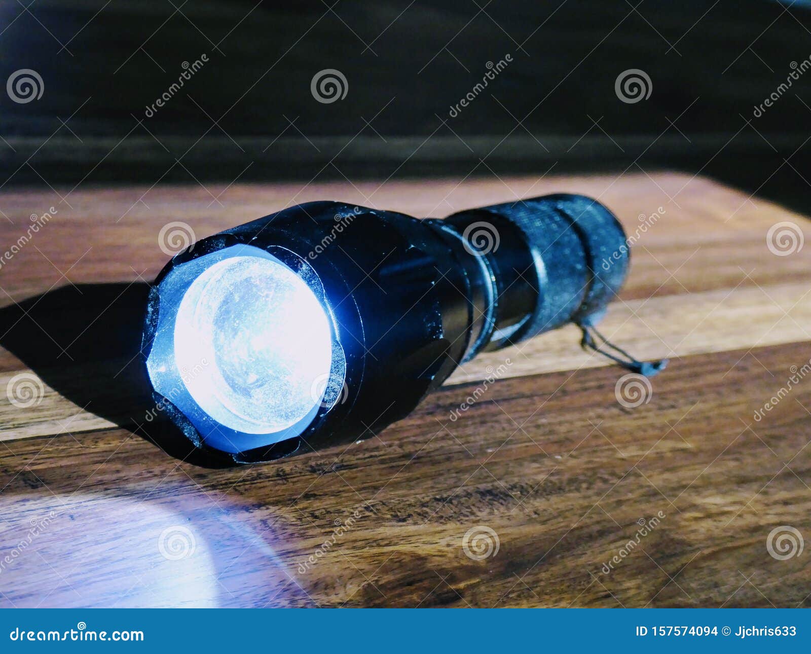 Flashlight Shining on Table. Turned of Torchlight. Stock Photo - Image ...