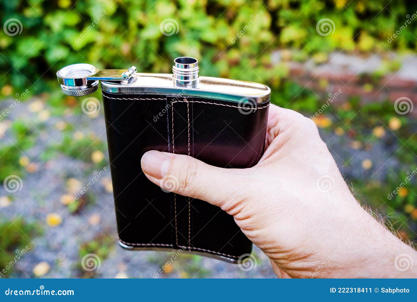 Flask in a Hand stock image. Image of alcoholism, hold - 222318411