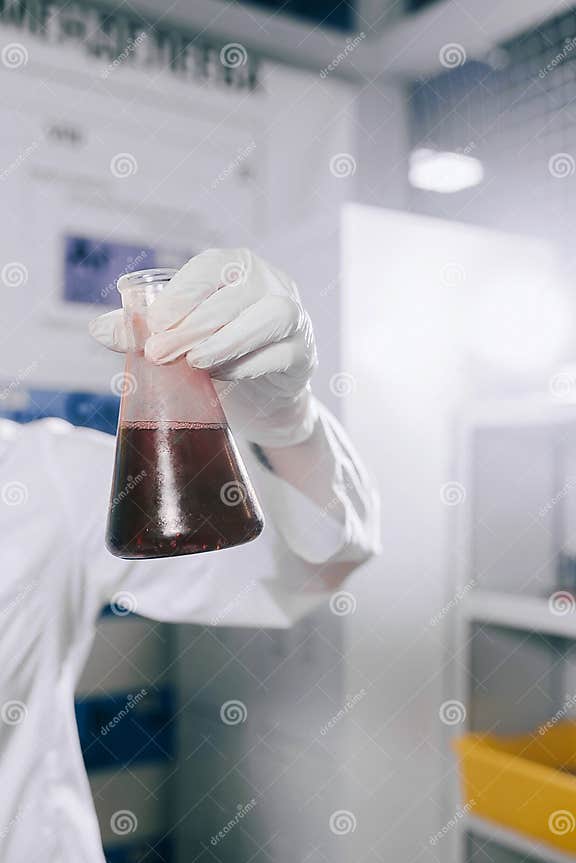The Flask is in the Hands of a Specialist. Stock Image - Image of ...