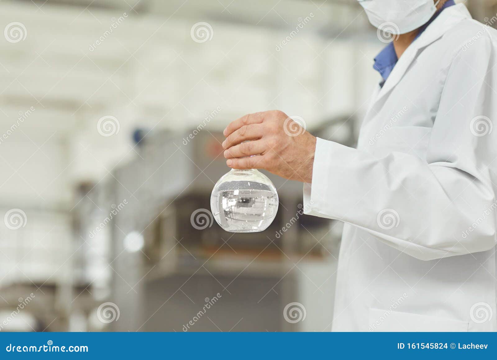 The Flask with the Water Test in the Hands of the Technologist on the ...