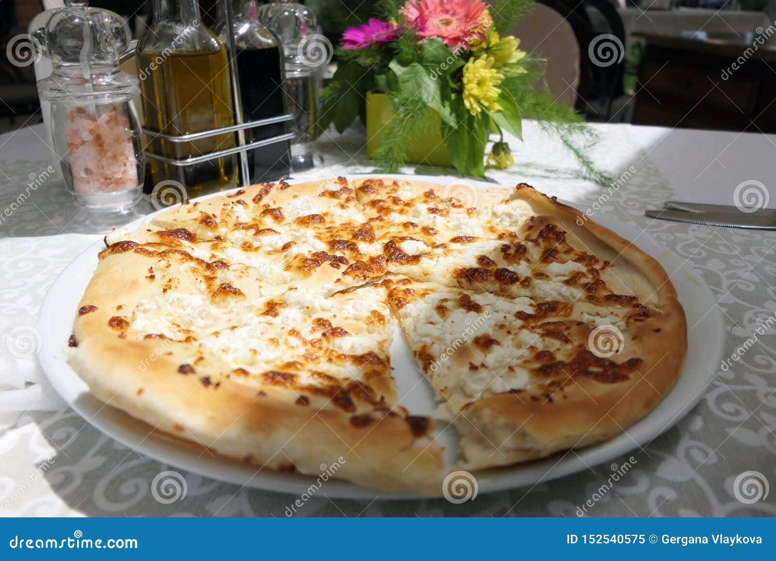 Flat Cheese Bread in a White Plate on a Restaurant Table Stock Image ...