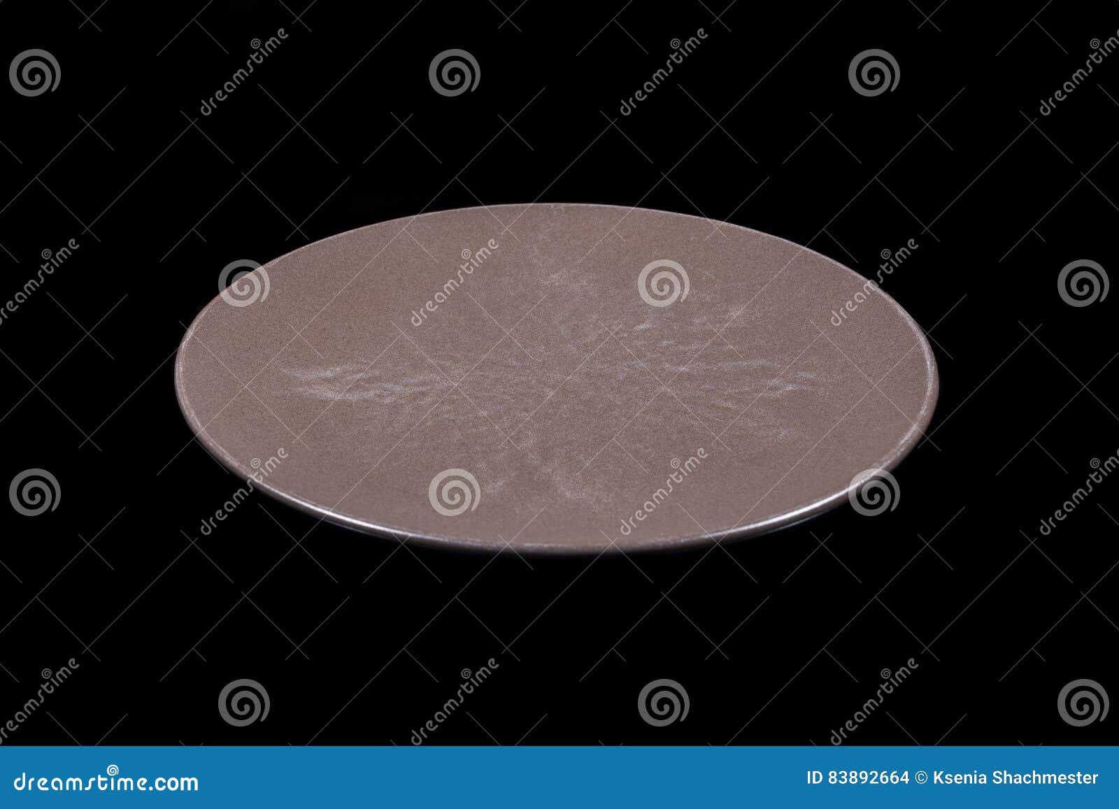 Flat Dark Brown Plate on Black Background from Side Stock Photo - Image ...