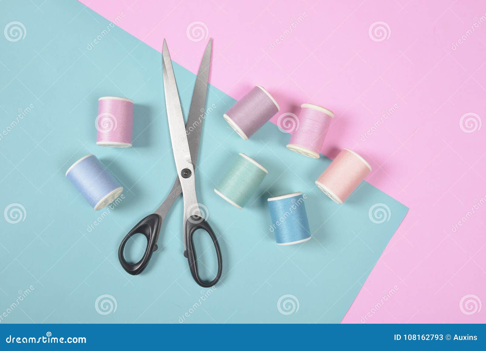 Flat Lay of Colored Thread Rolls and Scissors for Sewing on Two Stock ...
