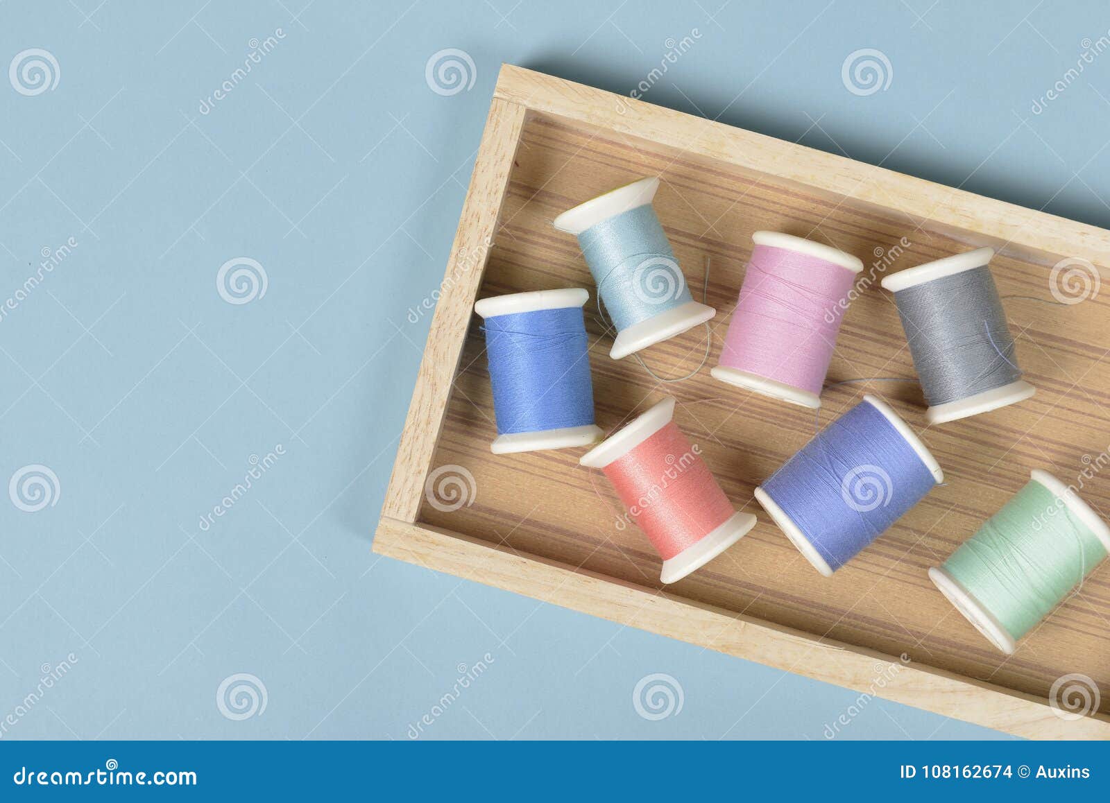 Flat Lay of Colored Thread Rolls for Sewing on Blue Background, Stock ...