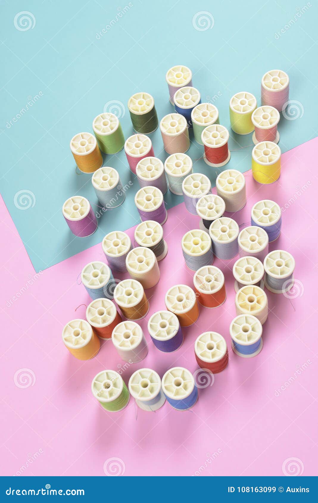 Flat Lay of Colored Thread Rolls for Sewing on Two Tone Background ...