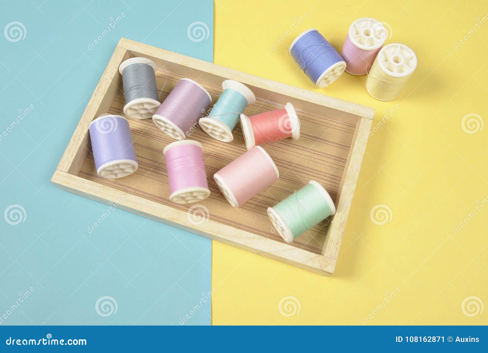 Flat Lay of Colored Thread Rolls for Sewing on Two Tone Background ...