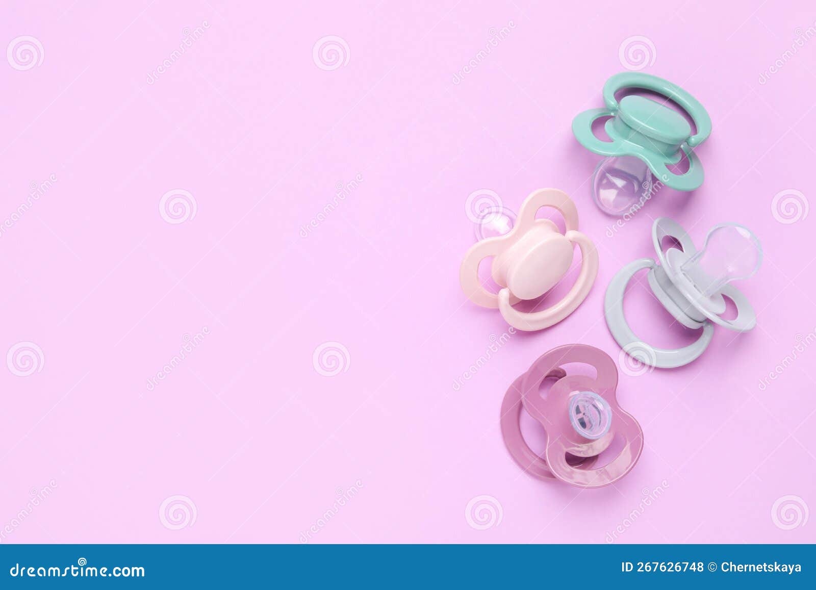 Flat Lay Composition with Baby Pacifiers on Violet Background. Space ...