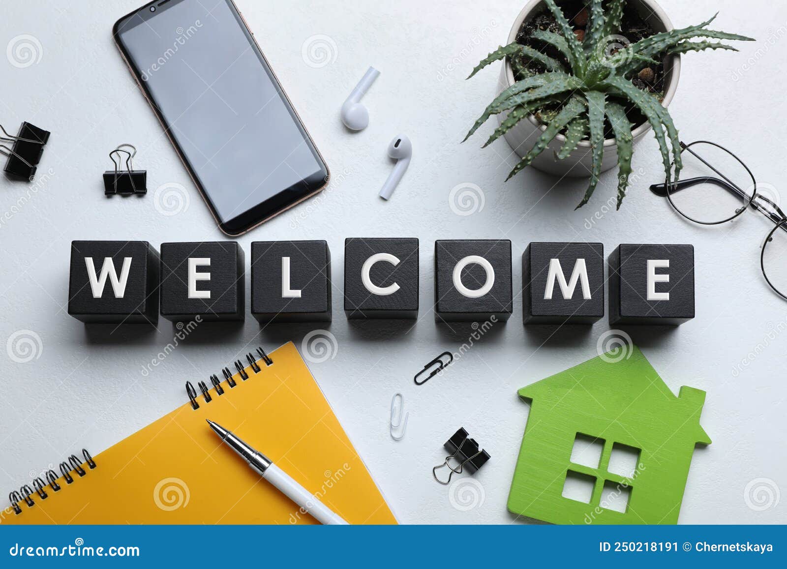Flat Lay Composition of Black Cubes with Word Welcome on White Table ...
