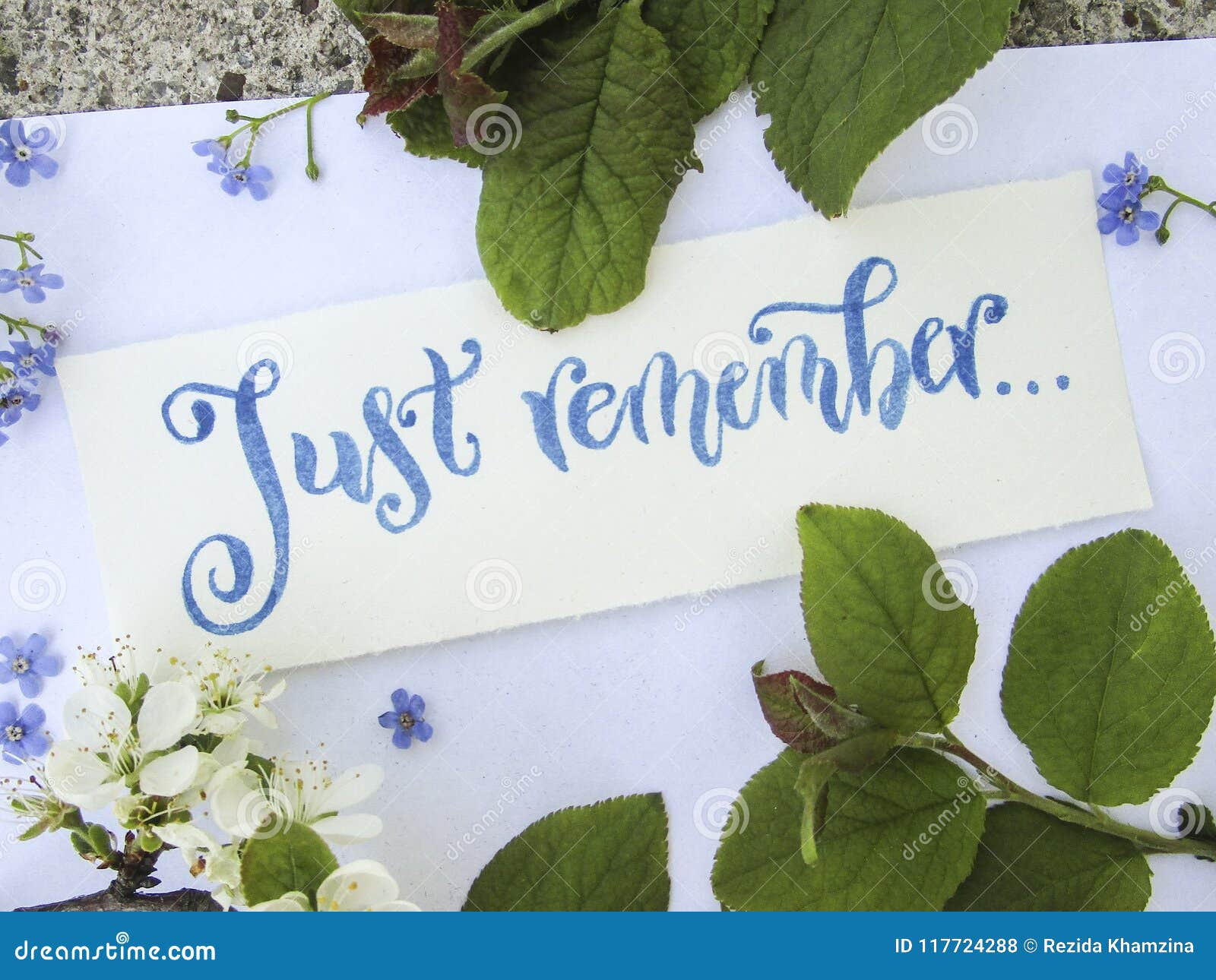 Flat Lay Composition With Calligraphy Of Just Remember In Blue On White ...