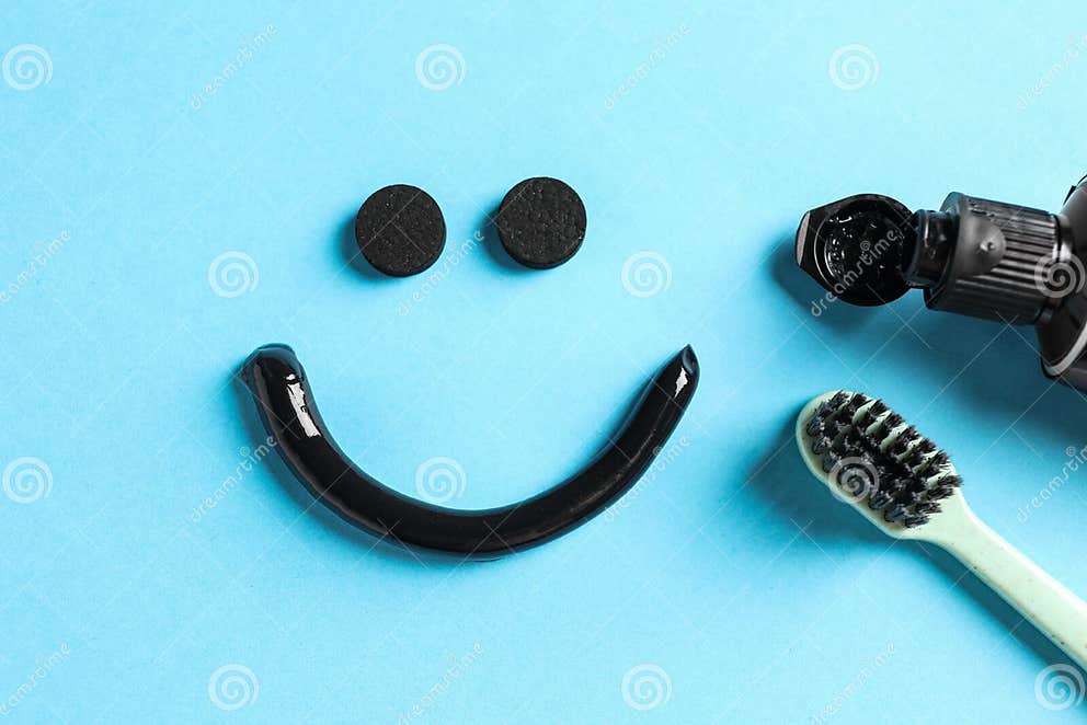 Flat Lay Composition with Charcoal Toothpaste on Light Blue Background ...