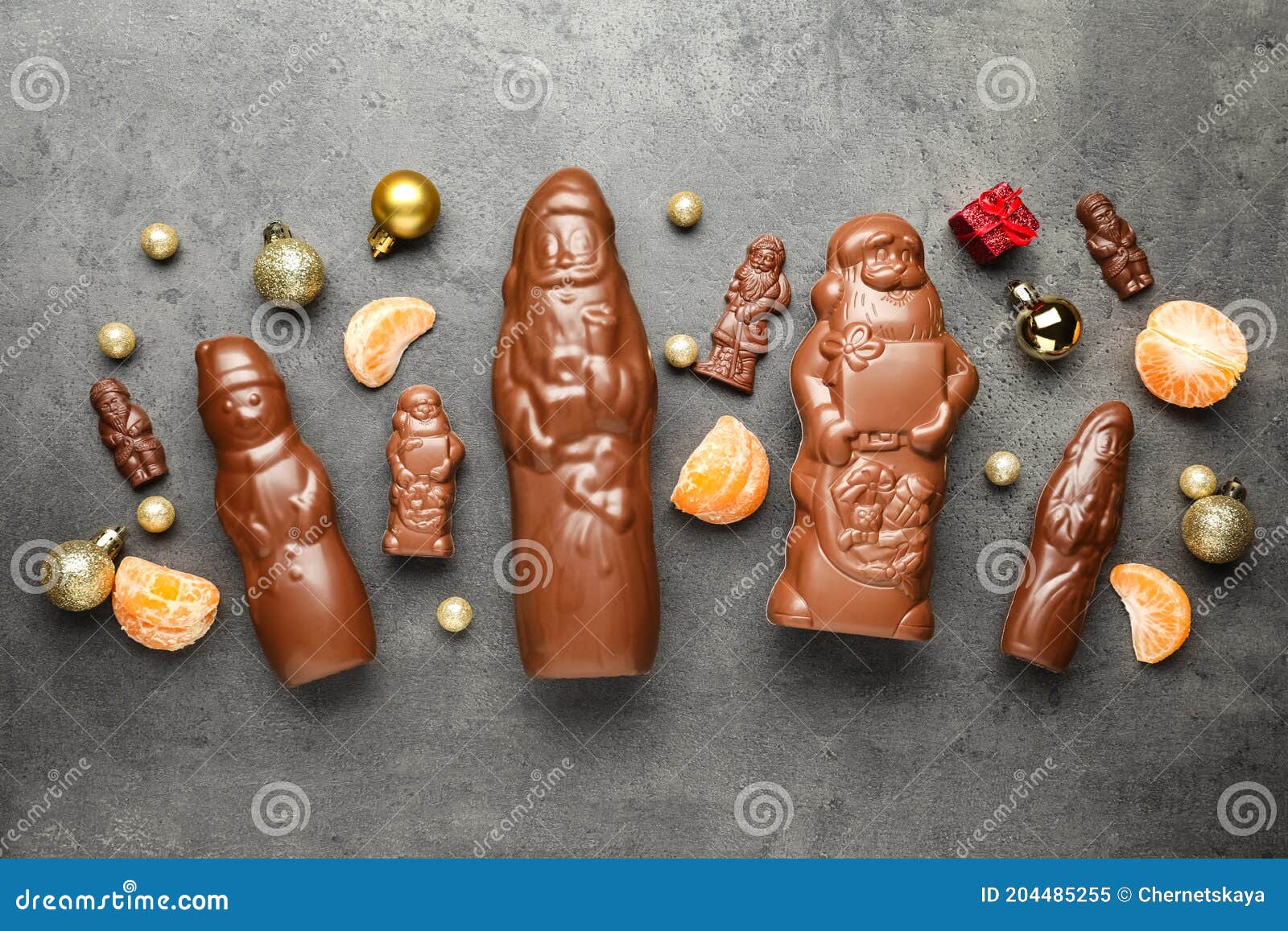 Flat Lay Composition with Chocolate Santa Claus Candies on Grey Table ...