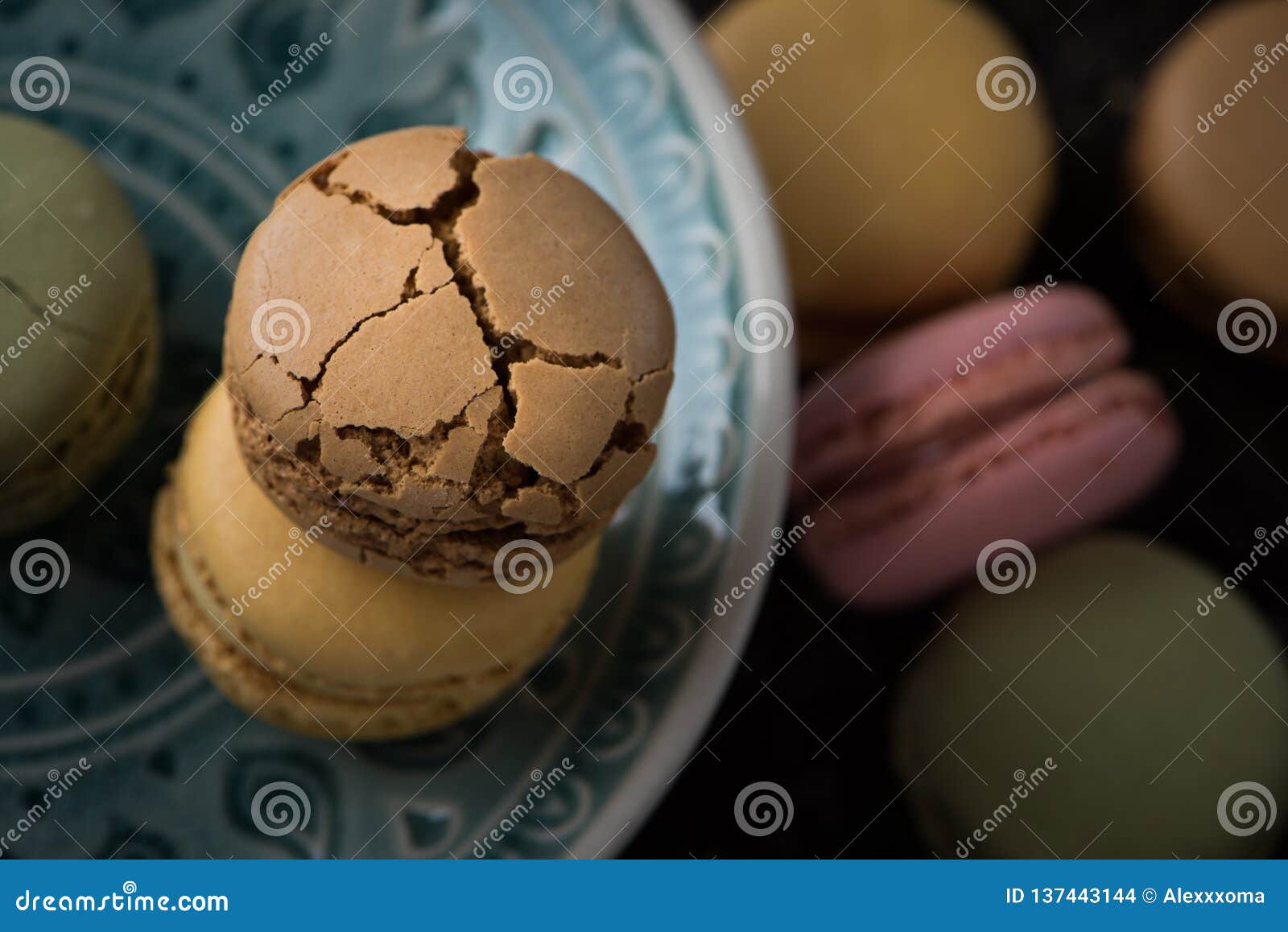 Flat Lay Composition with Cracked Macaroons on Green Plate Stock Photo ...