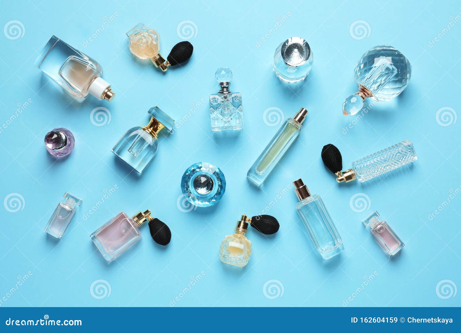 Flat Lay Composition with Different Perfume Bottles on Blue Background ...