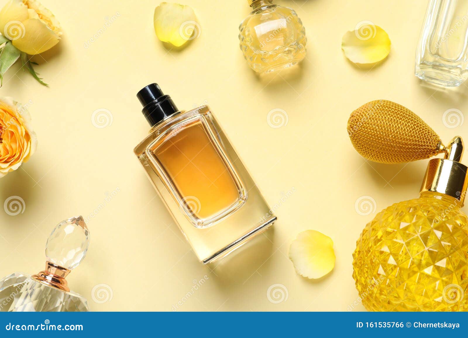 Flat Lay Composition with Different Perfume Bottles on Yellow ...